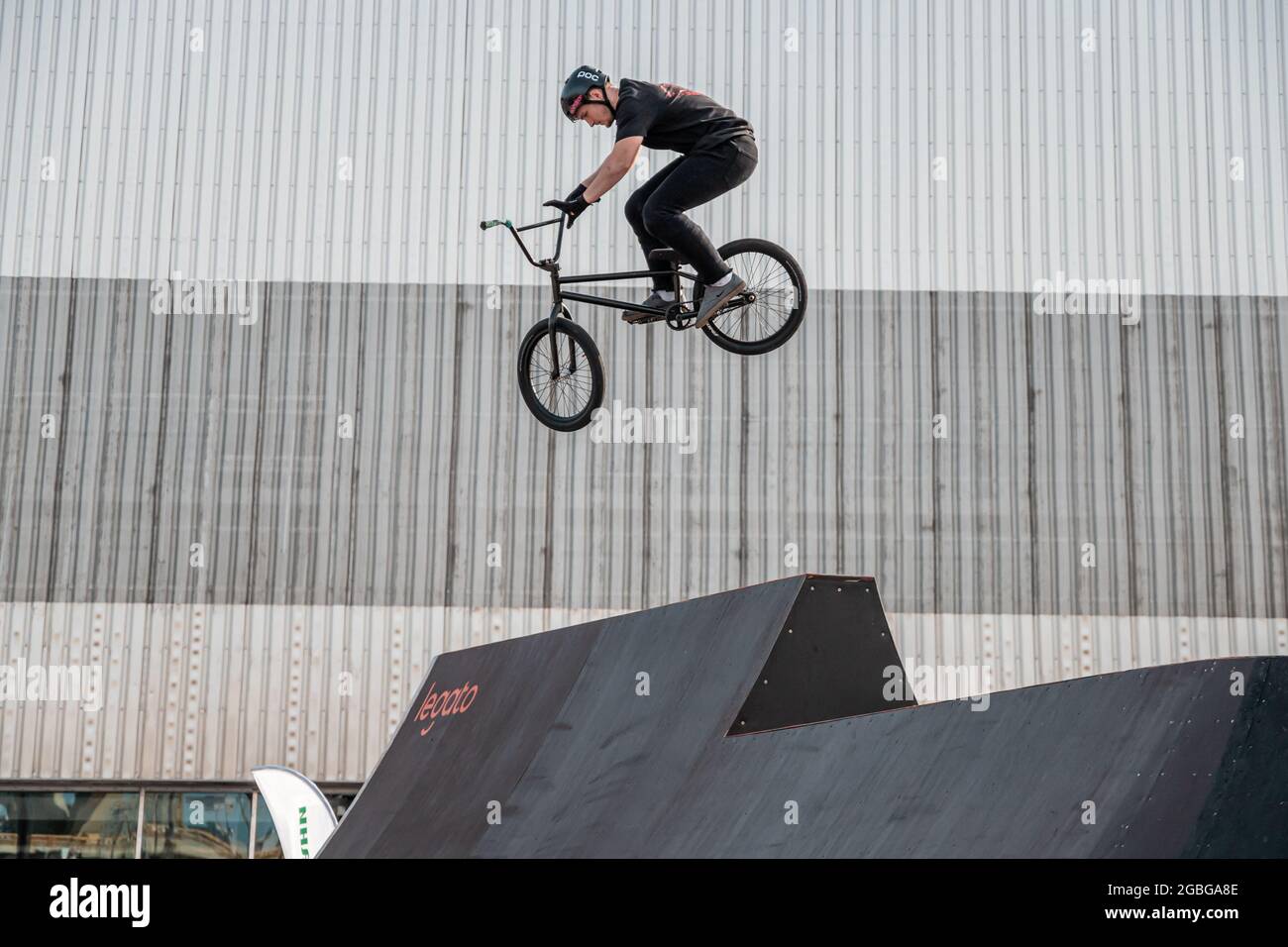 Kazan, Russia - September 26, 2020: A young rider on a BMX bike does tricks in the air. BMX ...