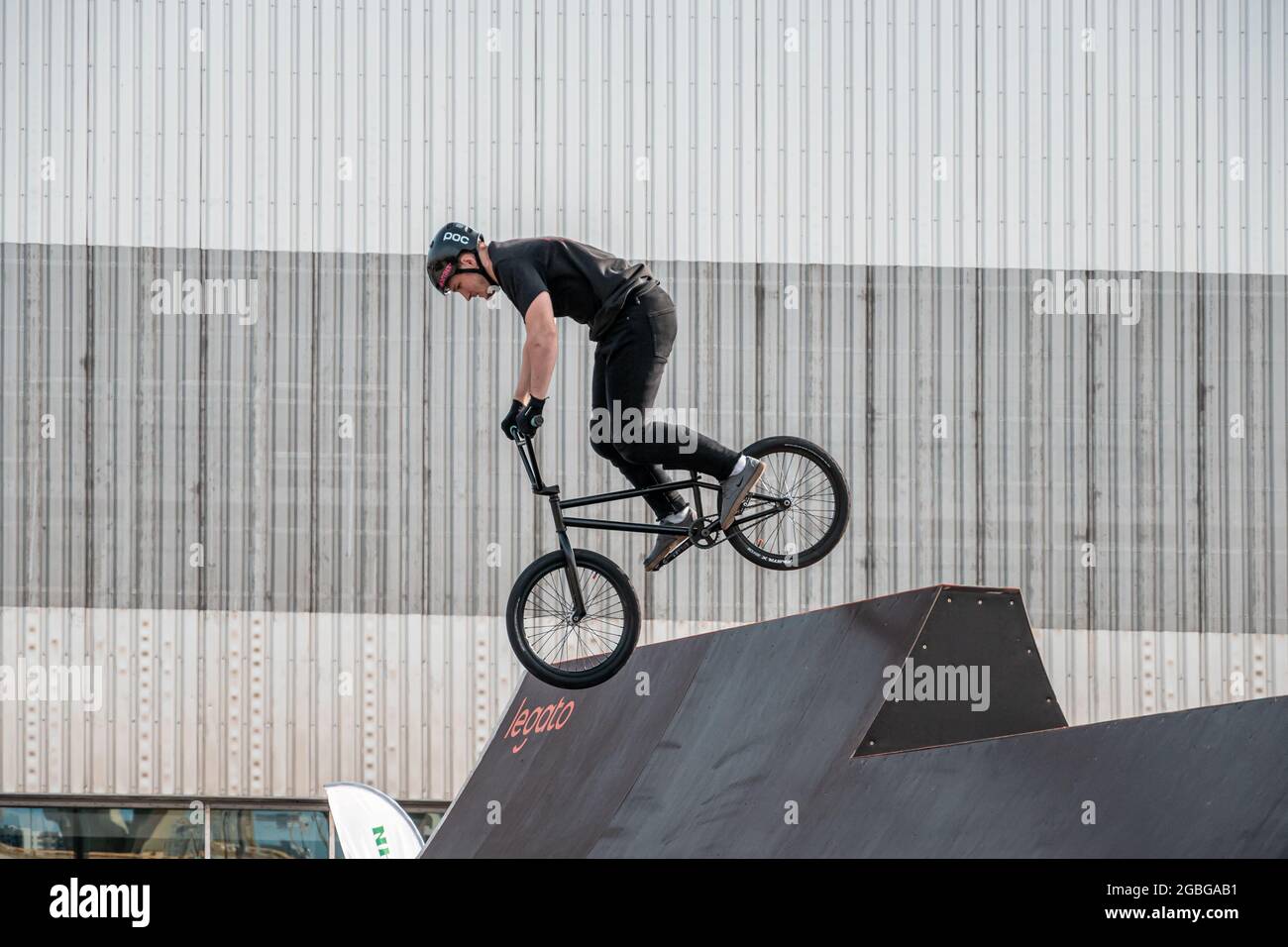 Kazan, Russia - September 26, 2020: A young rider on a BMX bike does tricks in the air. BMX ...