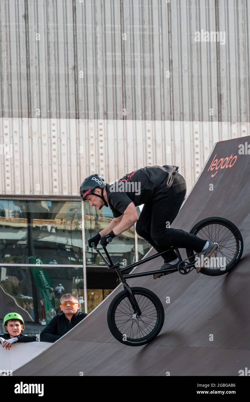 Kazan, Russia - September 26, 2020: A young rider does tricks on a BMX bike. BMX freestyle in a ...
