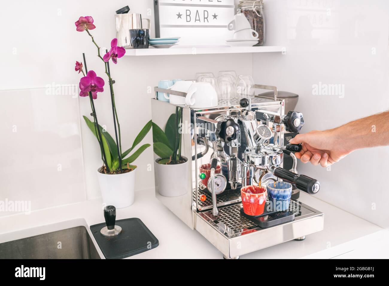 Coffee machine man barista making two espresso at home kitchen ...