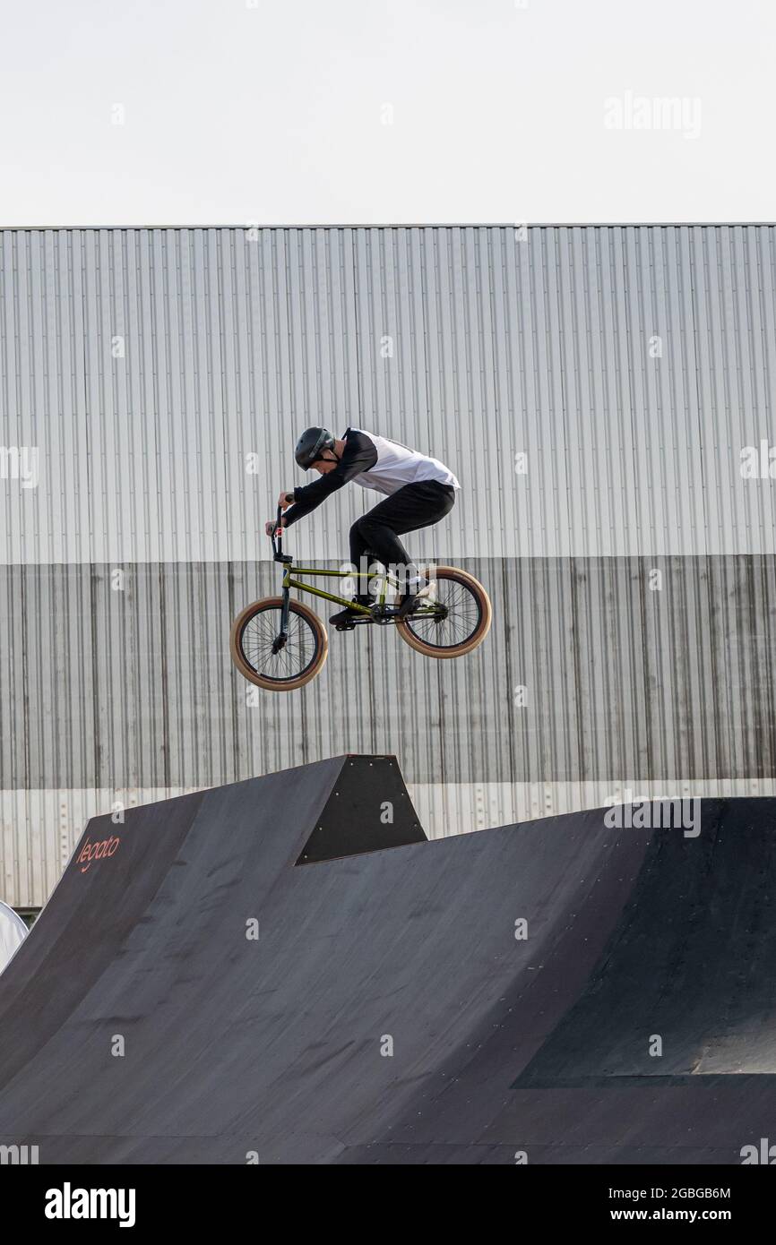 Kazan, Russia - September 26, 2020: A young rider on a BMX bike does tricks in the air. BMX ...