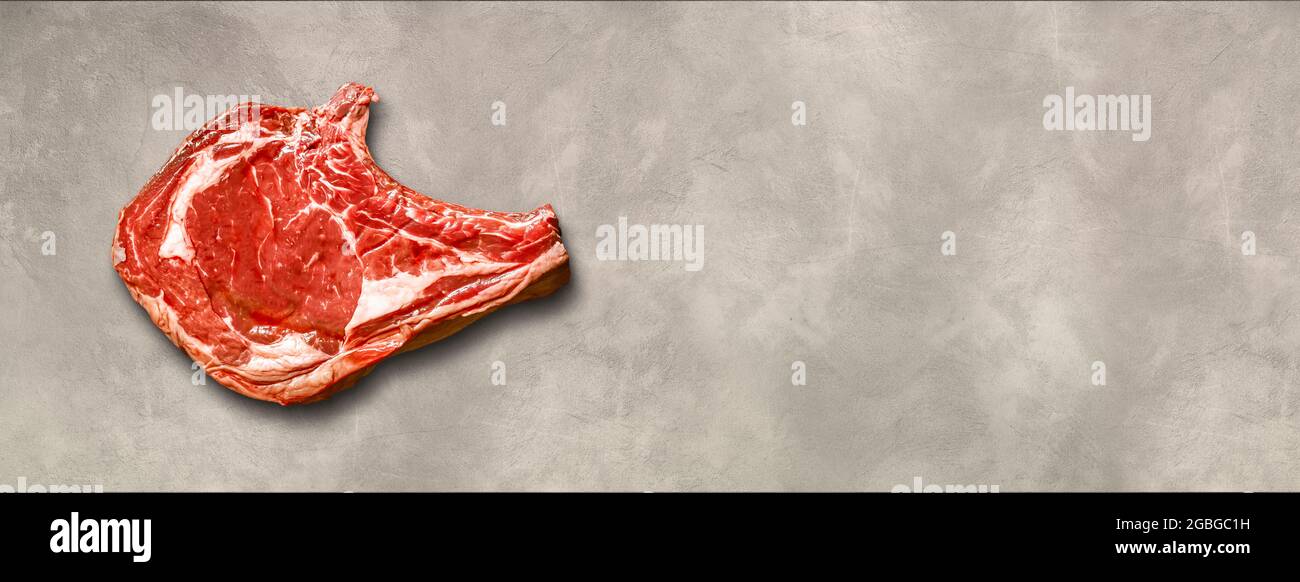 Raw beef prime rib isolated on light concrete background. Top view ...