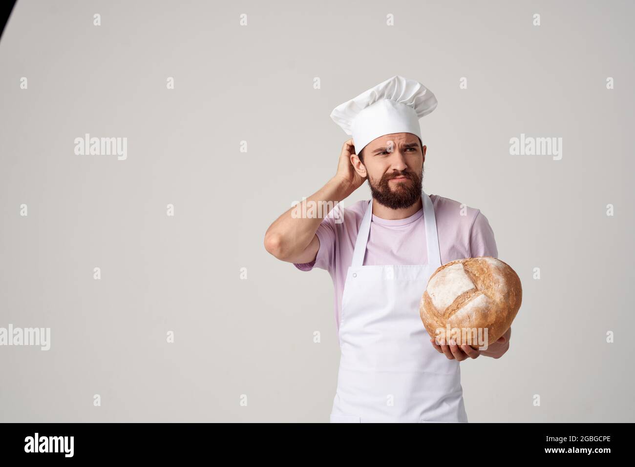 a man in a baker's uniform cooking bread Stock Photo - Alamy