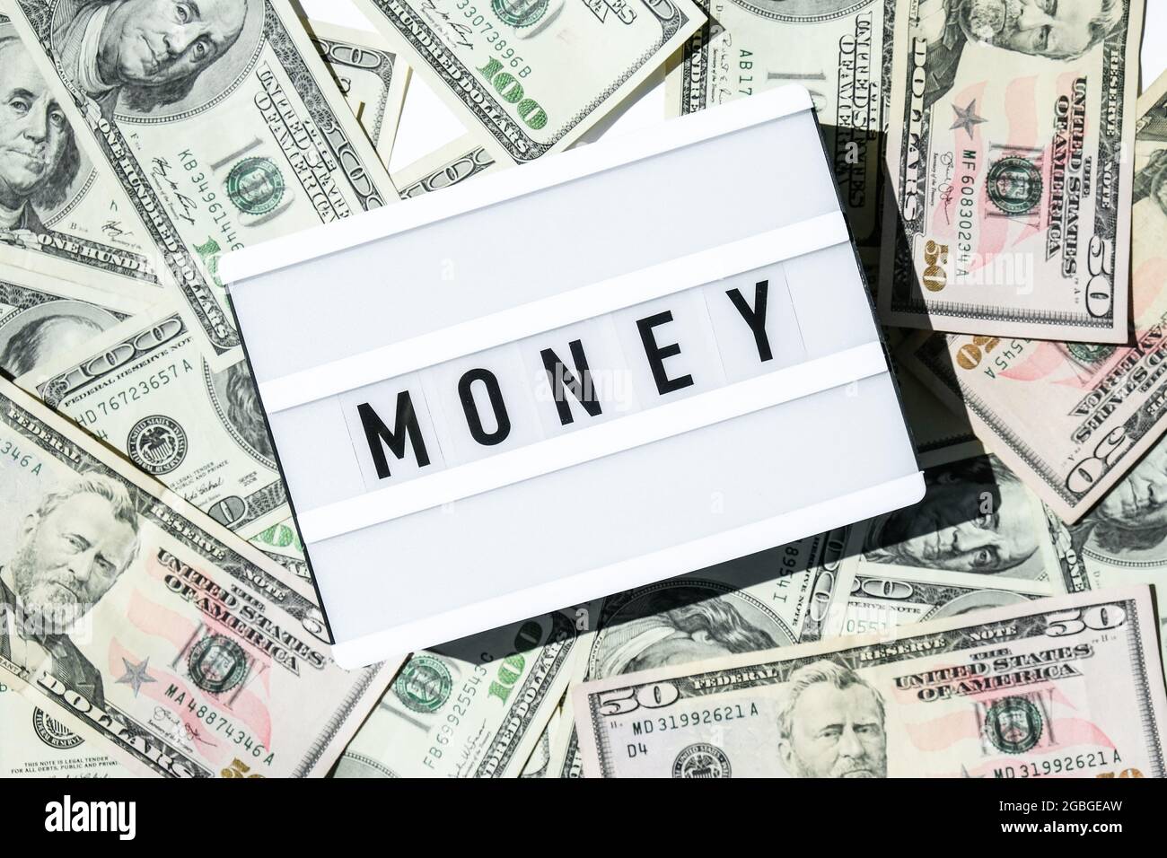 Lightbox board with the word MONEY in black letters around Us dollar ...