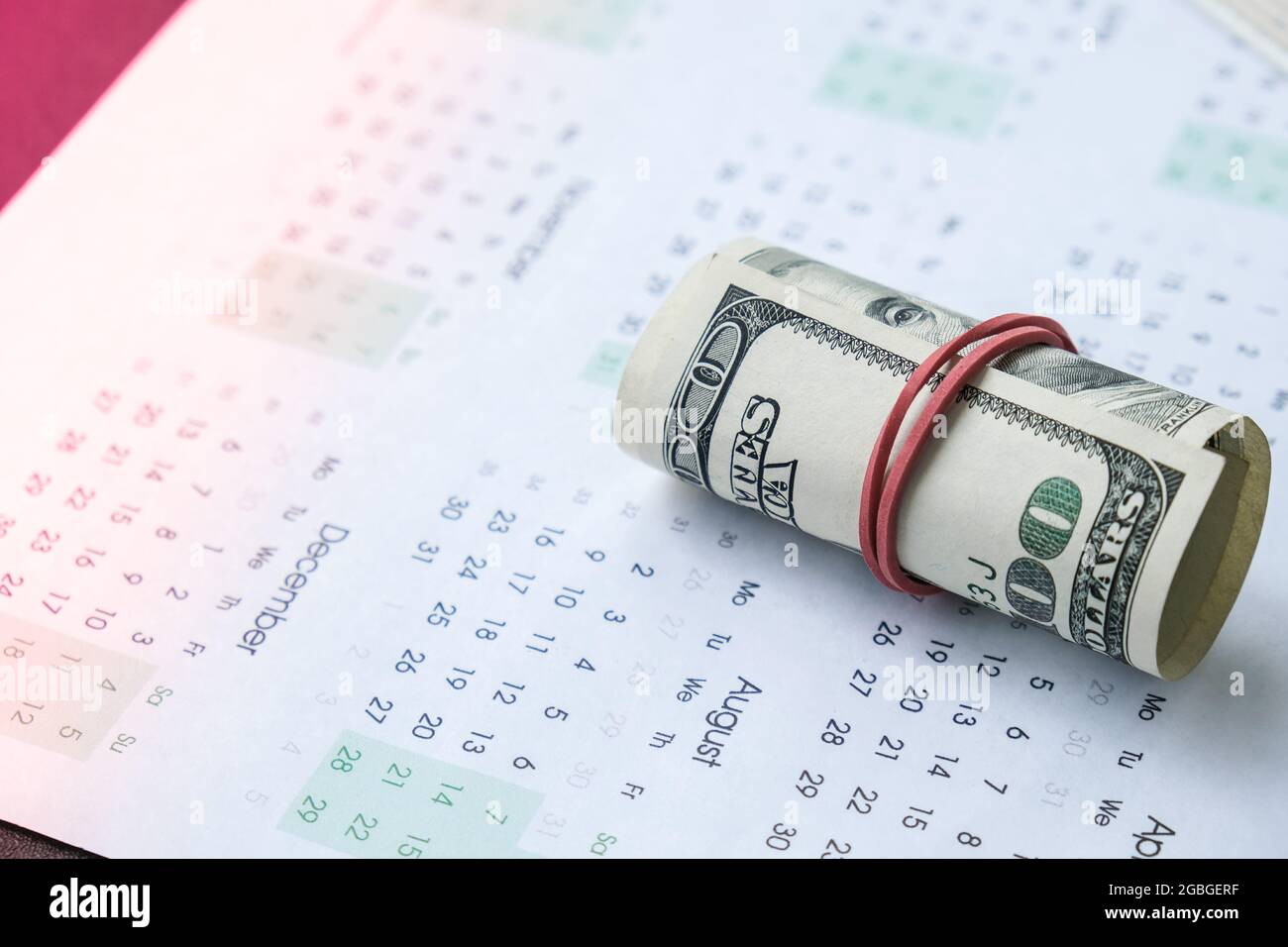 Office workplace desk with dollars and calendar. Counting money for ...