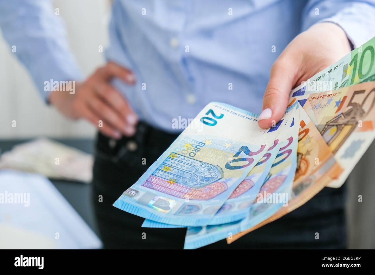 Business Woman Displaying a Spread of Cash euros. Close-up. Income and ...
