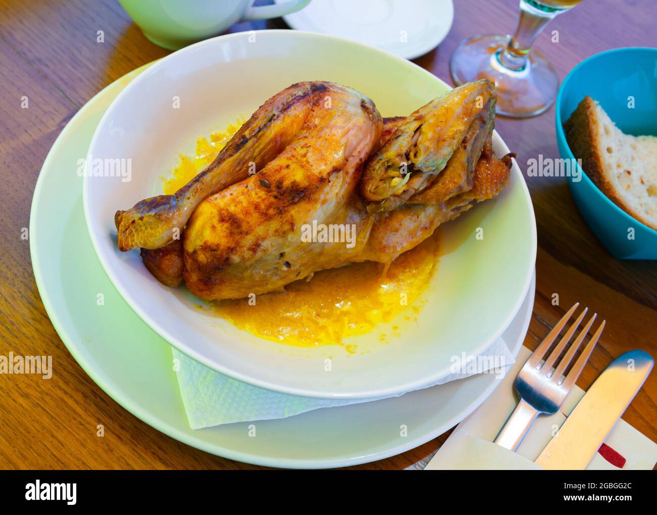 Baked chicken half with sauce. Swiss cuisine Stock Photo - Alamy