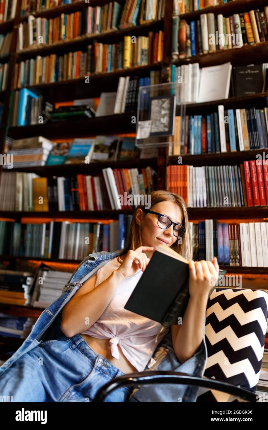 Young female student study in the library holding book , education ...