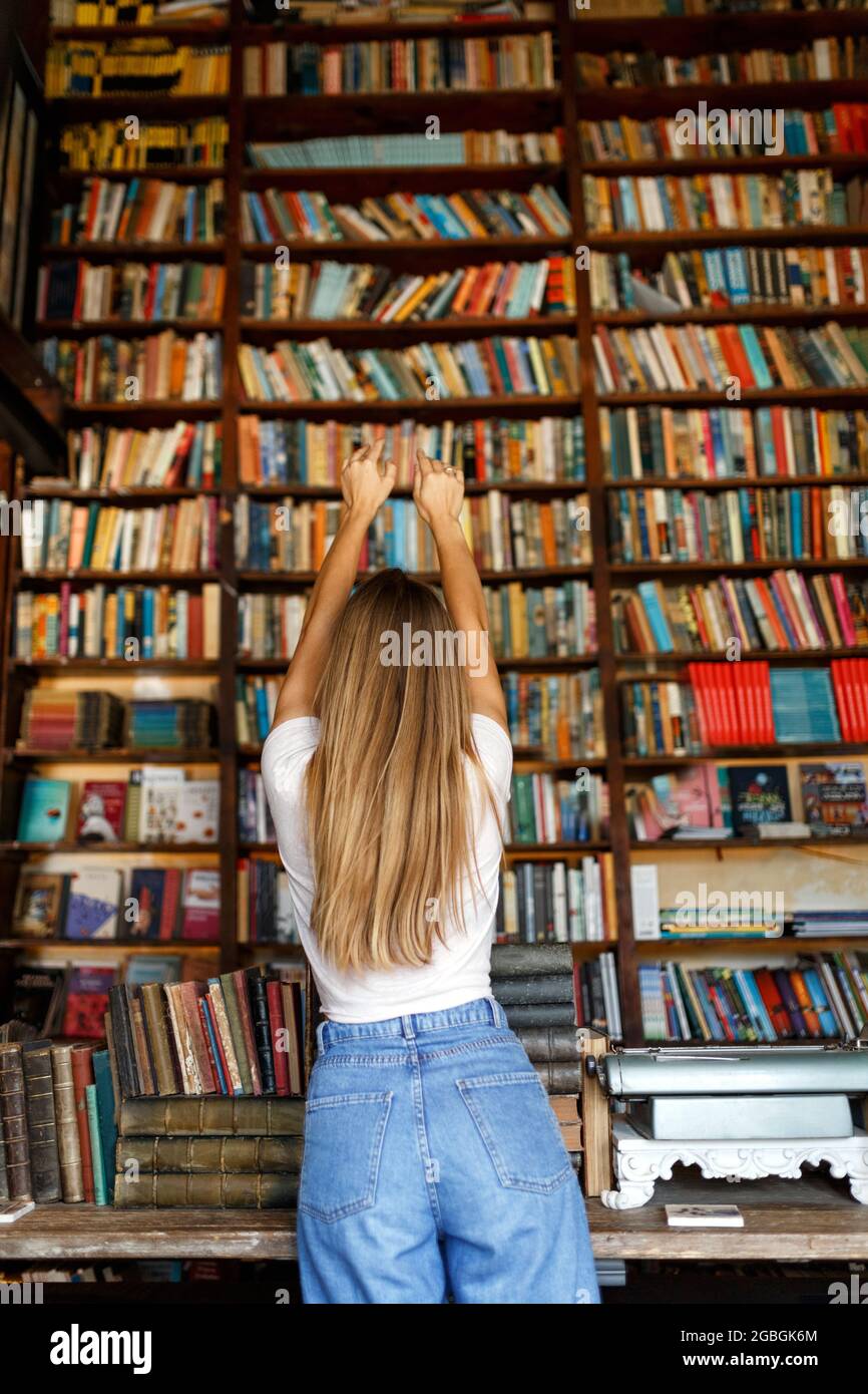 Young female student study in the library holding book , education ...