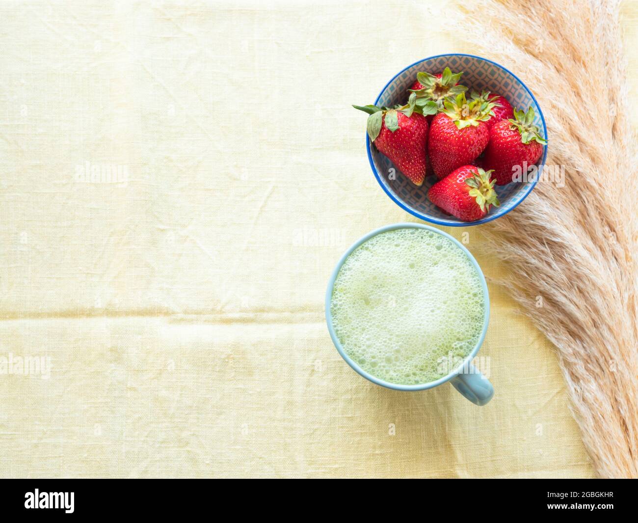 Matcha tea latte morning antioxidant hot drink in blue cup on yellow ...