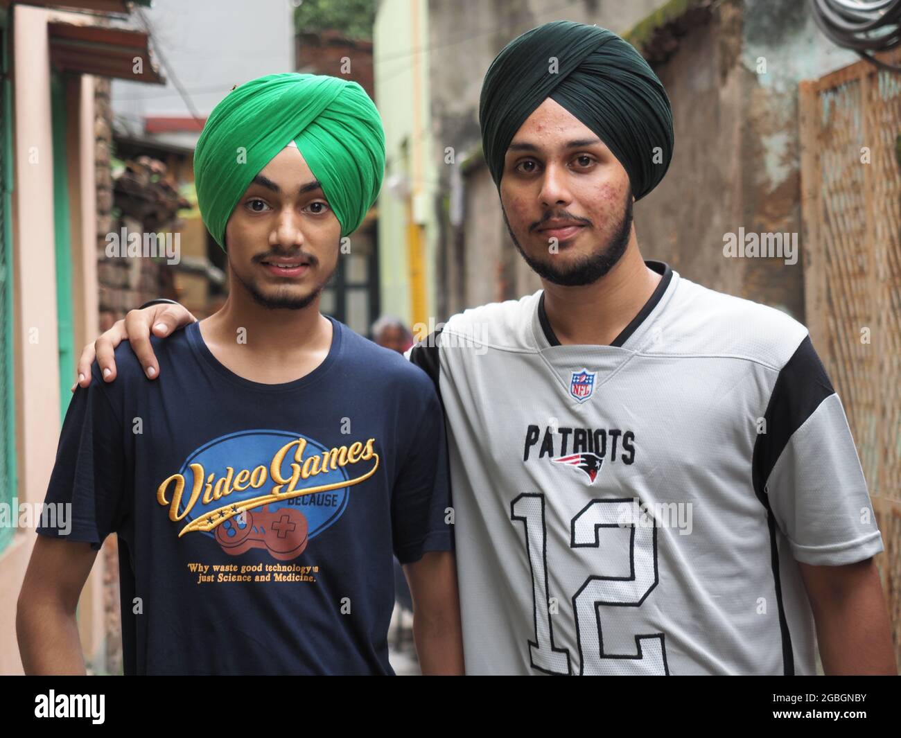 Indian Sikh teen boy wears an black patka in green outdoor background ...