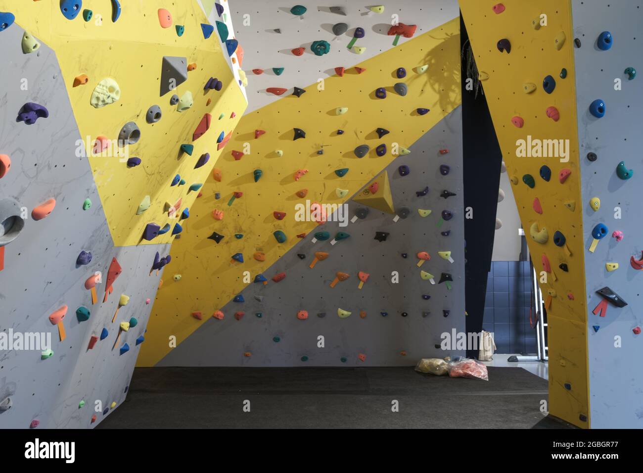 Empty gray and yellow bouldering walls with colorful handles Stock ...