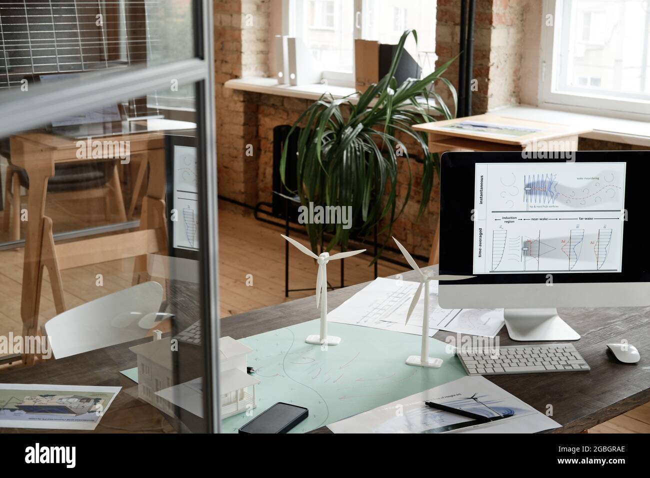 Image of workplace of engineer blueprints and graphics on computer ...