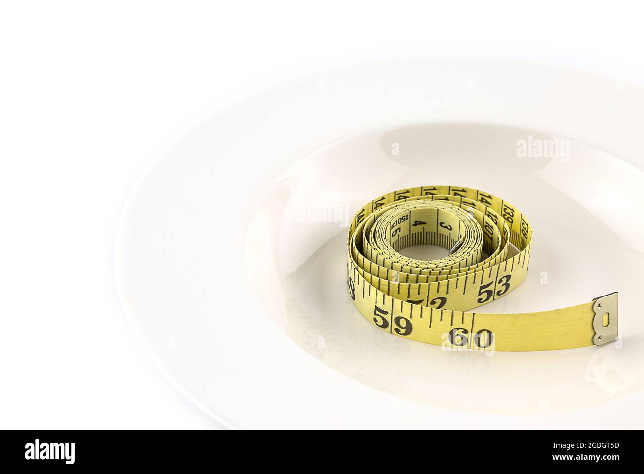 Tape measure with on white plate isolated withe background Stock Photo ...