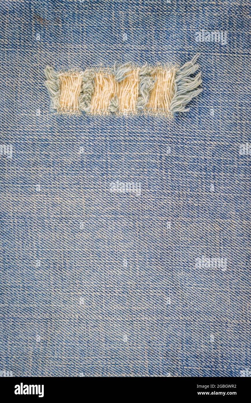blue jean texture with a hole and threads showing background Stock ...