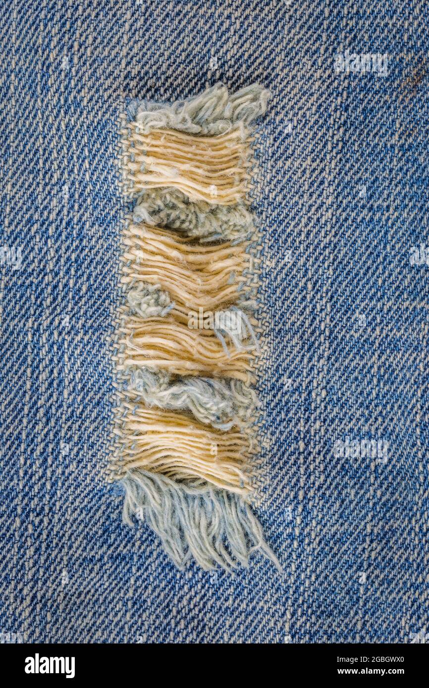 blue jean texture with a hole and threads showing background Stock ...