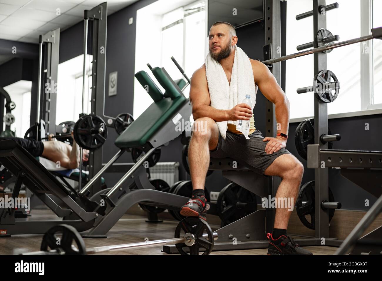 Strong bodybuilder with muscular chest and shoulders in gym Stock Photo ...