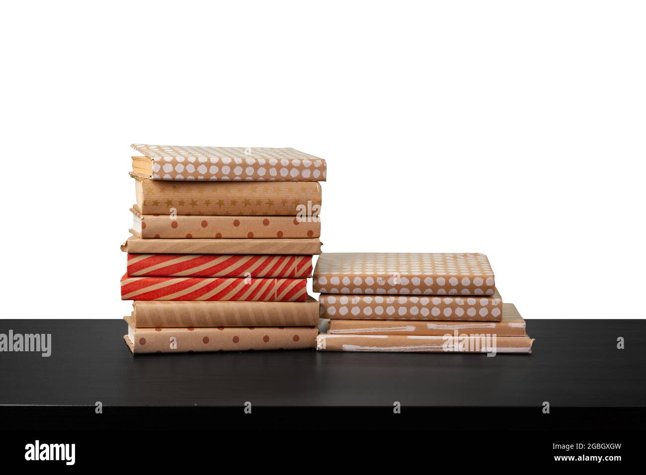 Stack of books on wooden table against white background Stock Photo - Alamy