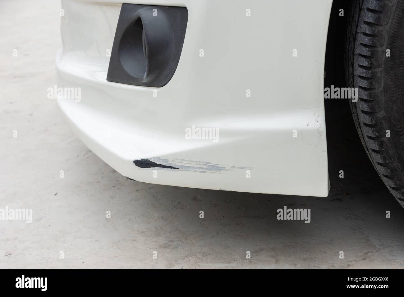 Close-up of crashed car's front area with cracks deep damage to the ...