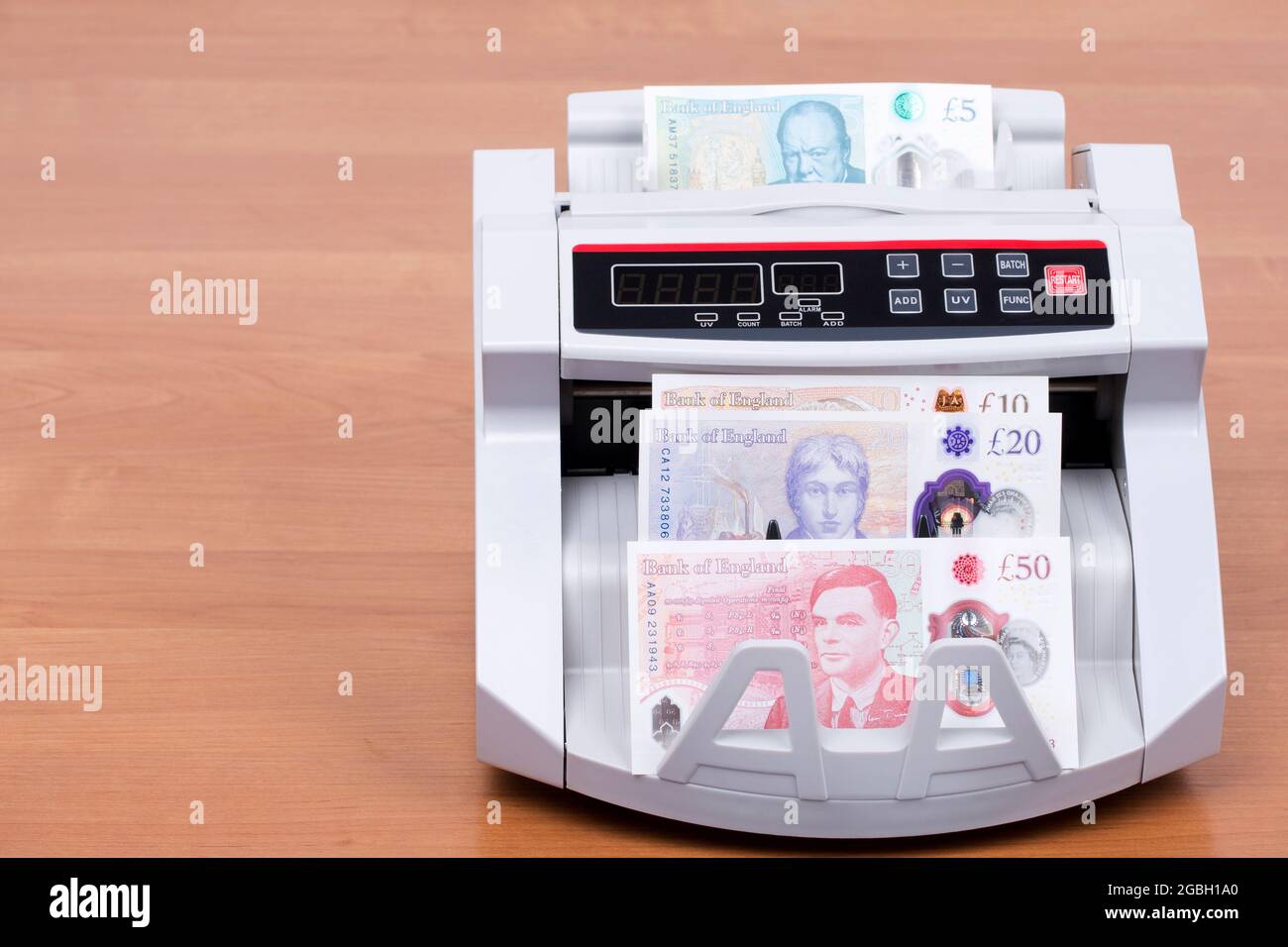 English Pounds in a counting machine Stock Photo - Alamy