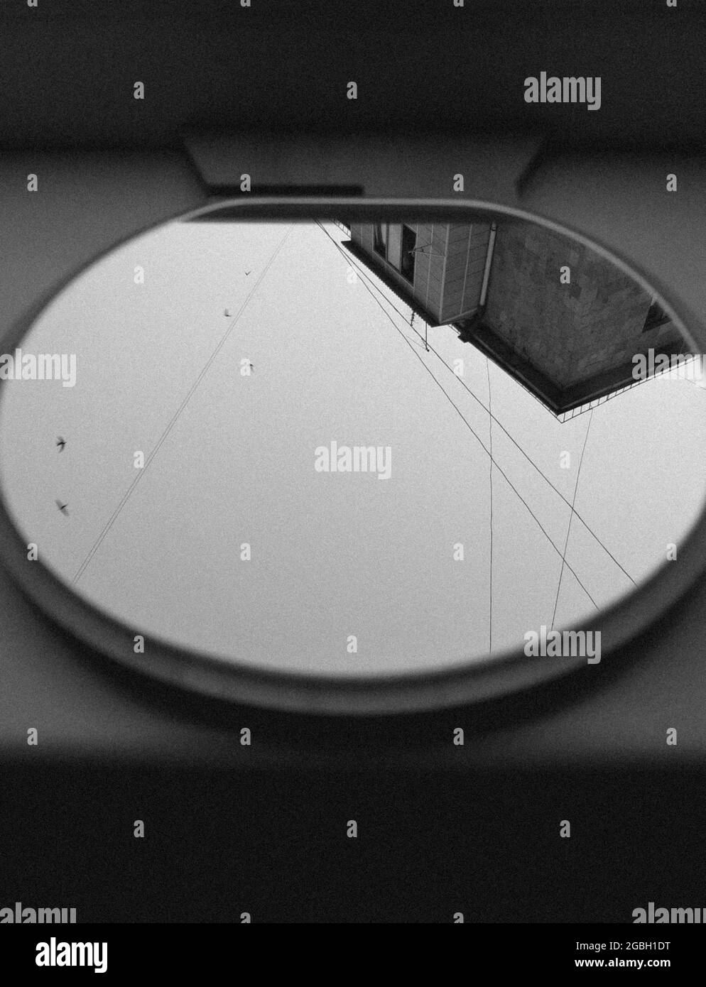 Selective of the building top reflected on the round mirror Stock Photo ...