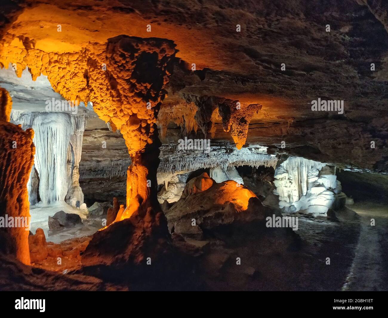 Underground cave with white and yellow light Stock Photo - Alamy