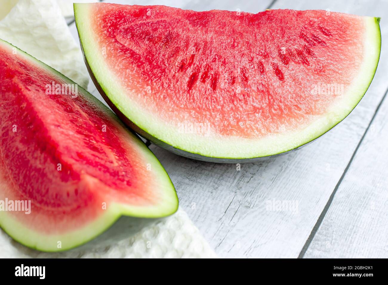 Bright sweet red and green watermelon slices in summer on light table ...