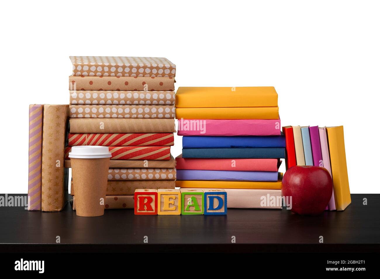 Stack of books and apple on tabletop against white background Stock ...