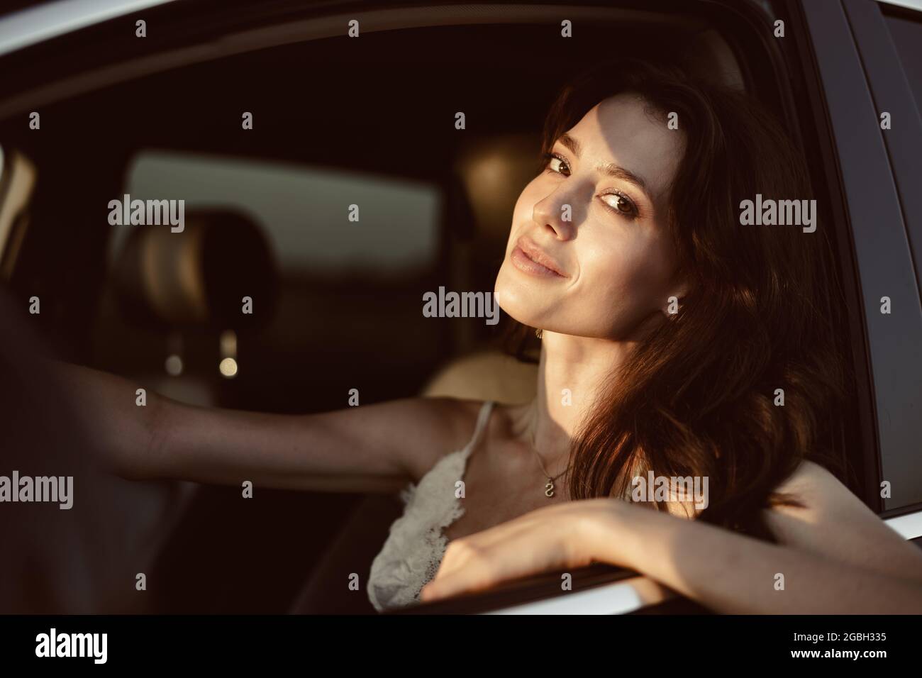 Beautiful smiling woman driving her car in the morning Stock Photo - Alamy