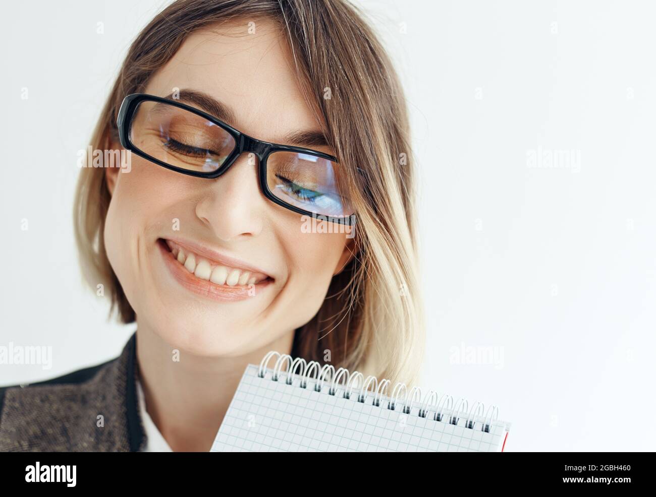 Business woman with notepad in hands office light background Copy Space ...