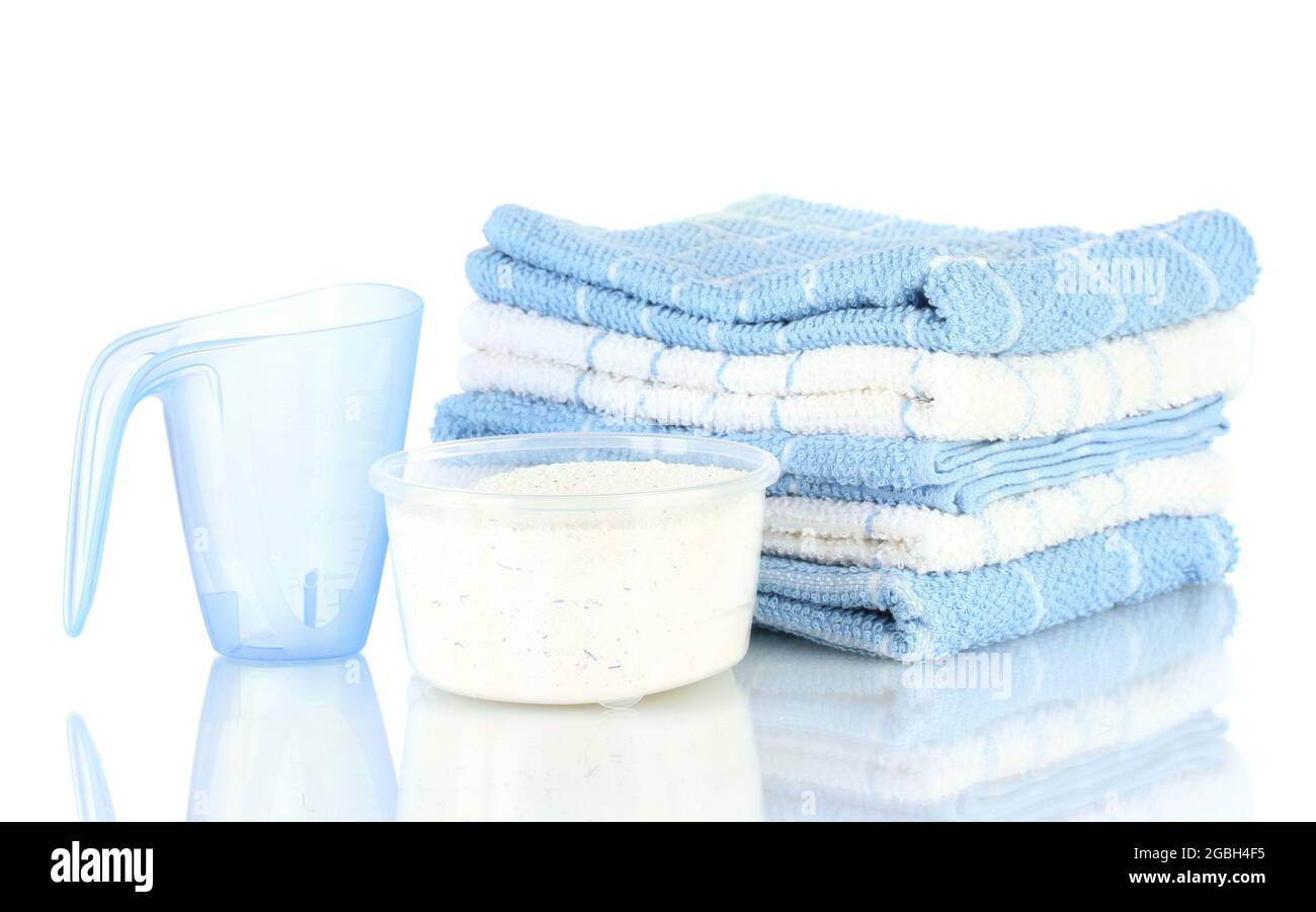 measuring cups with washing powder and towels, isolated on white Stock ...