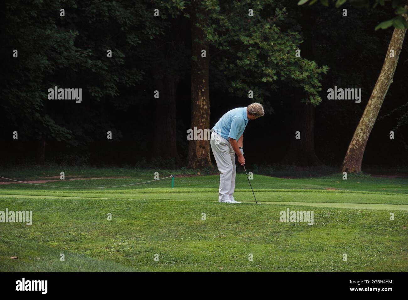 old man senior practicing golf in the Green grass field - activity ...
