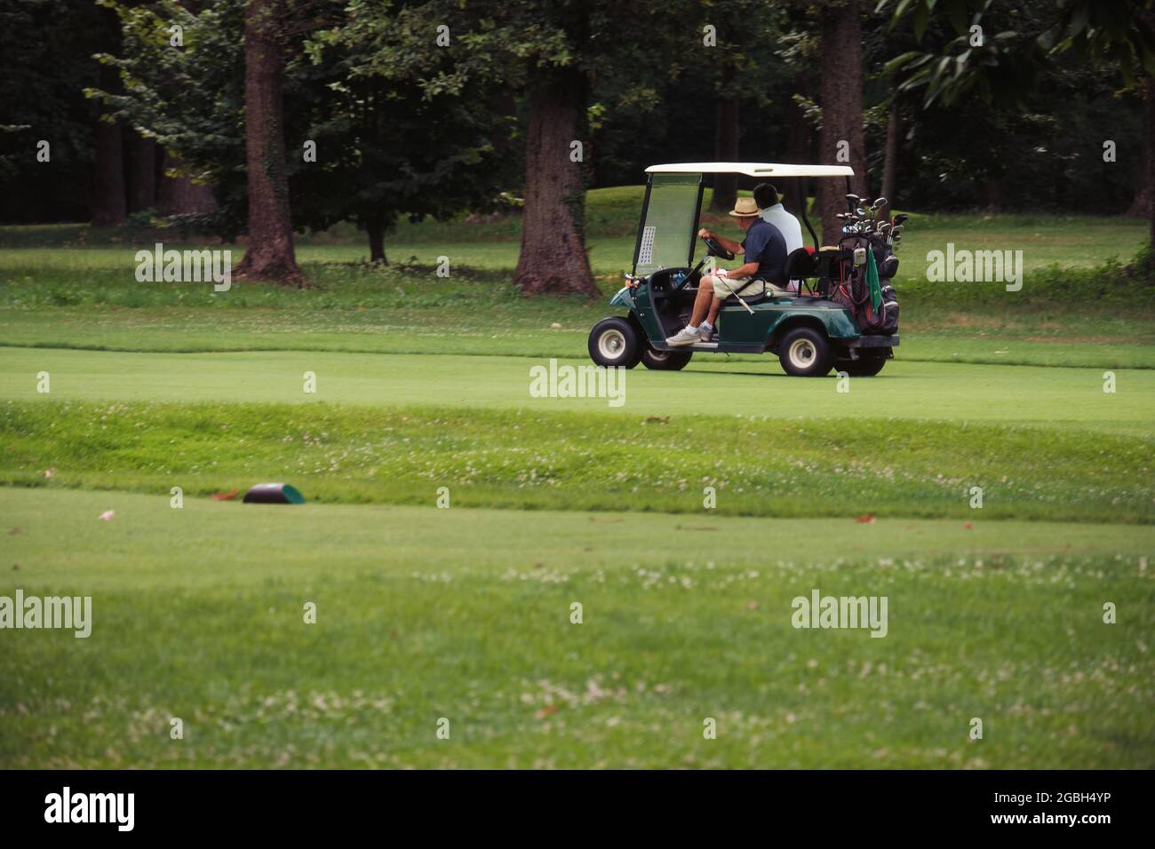 little car for golf in the Green grass field - activity concept Stock ...