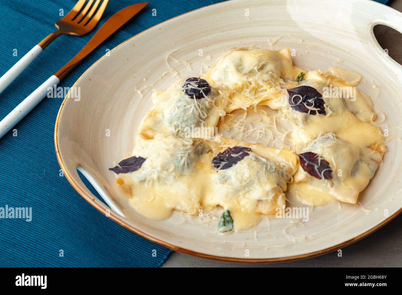 Italian dish ravioli with parmesan in a plate Stock Photo - Alamy