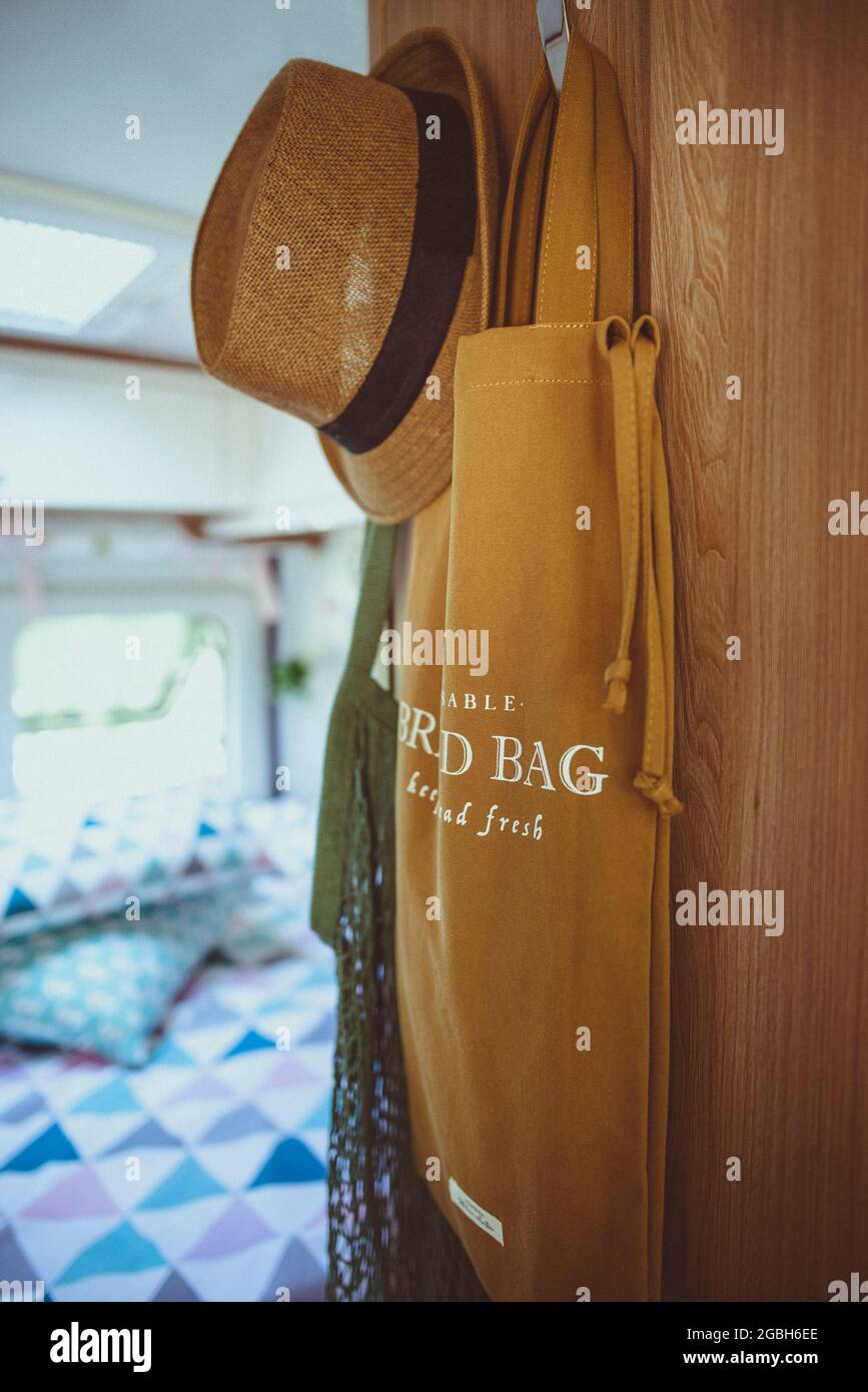 Close-up of a straw hat and bags hanging inside a camper van Stock ...