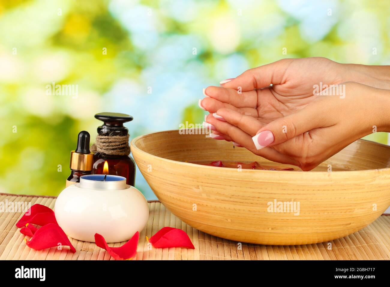 spa treatments for female hands, on green background Stock Photo - Alamy