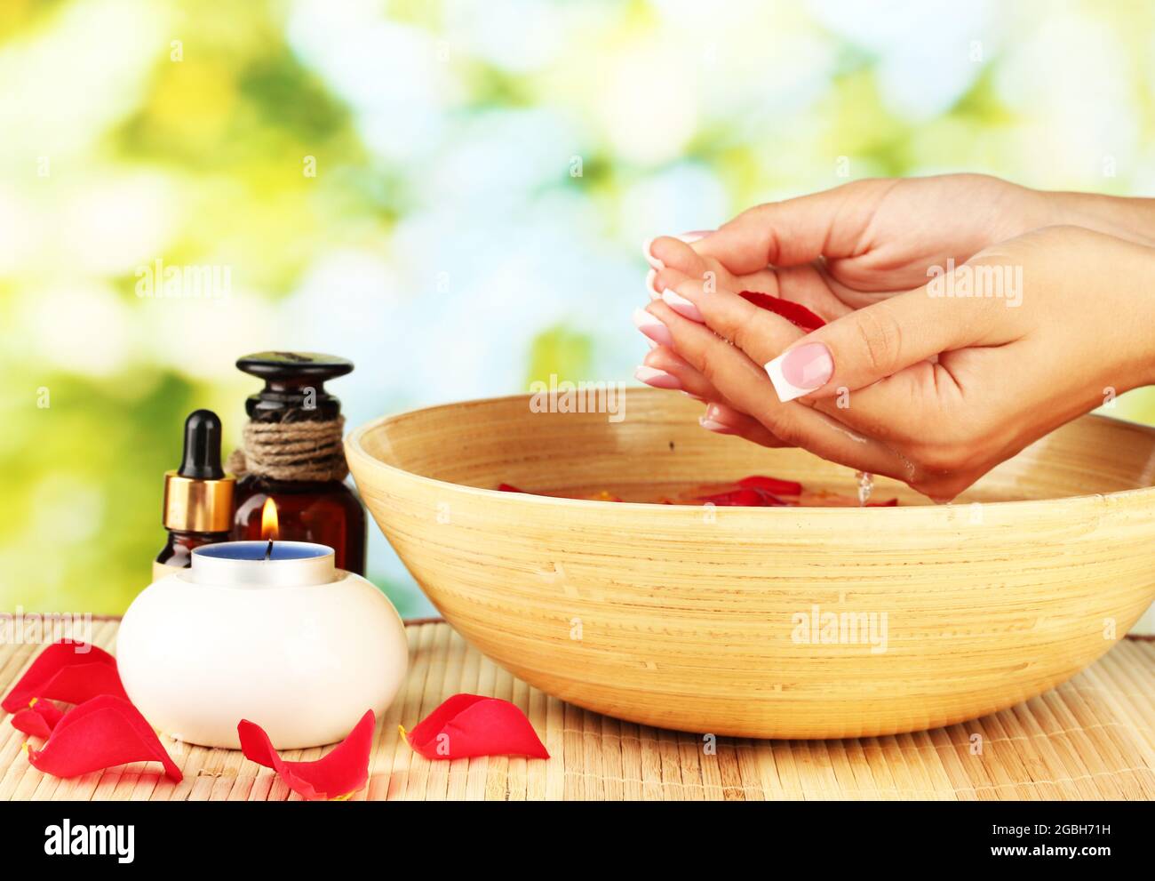 spa treatments for female hands, on green background Stock Photo - Alamy
