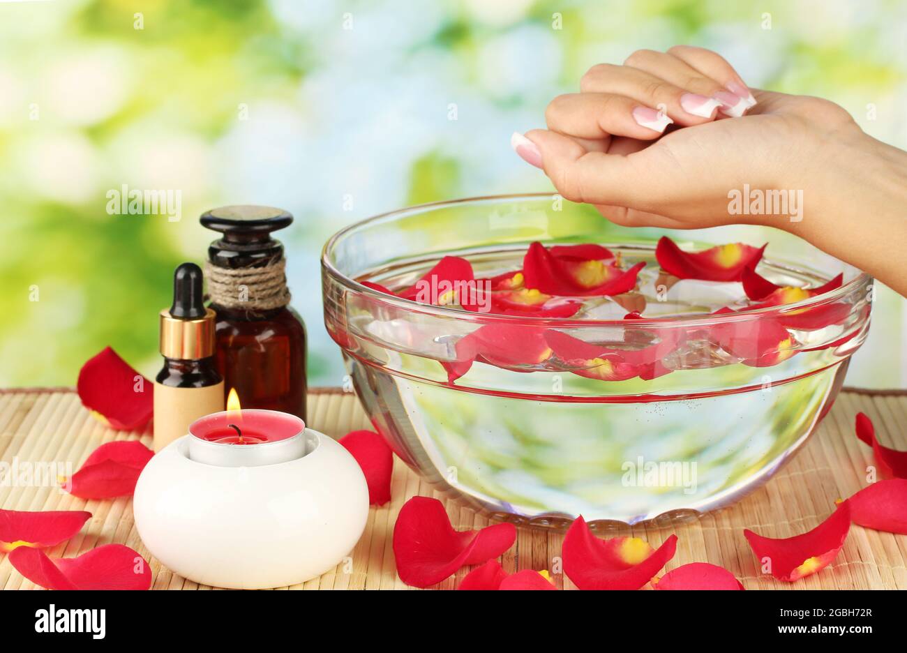 spa treatments for female hands, on green background Stock Photo - Alamy