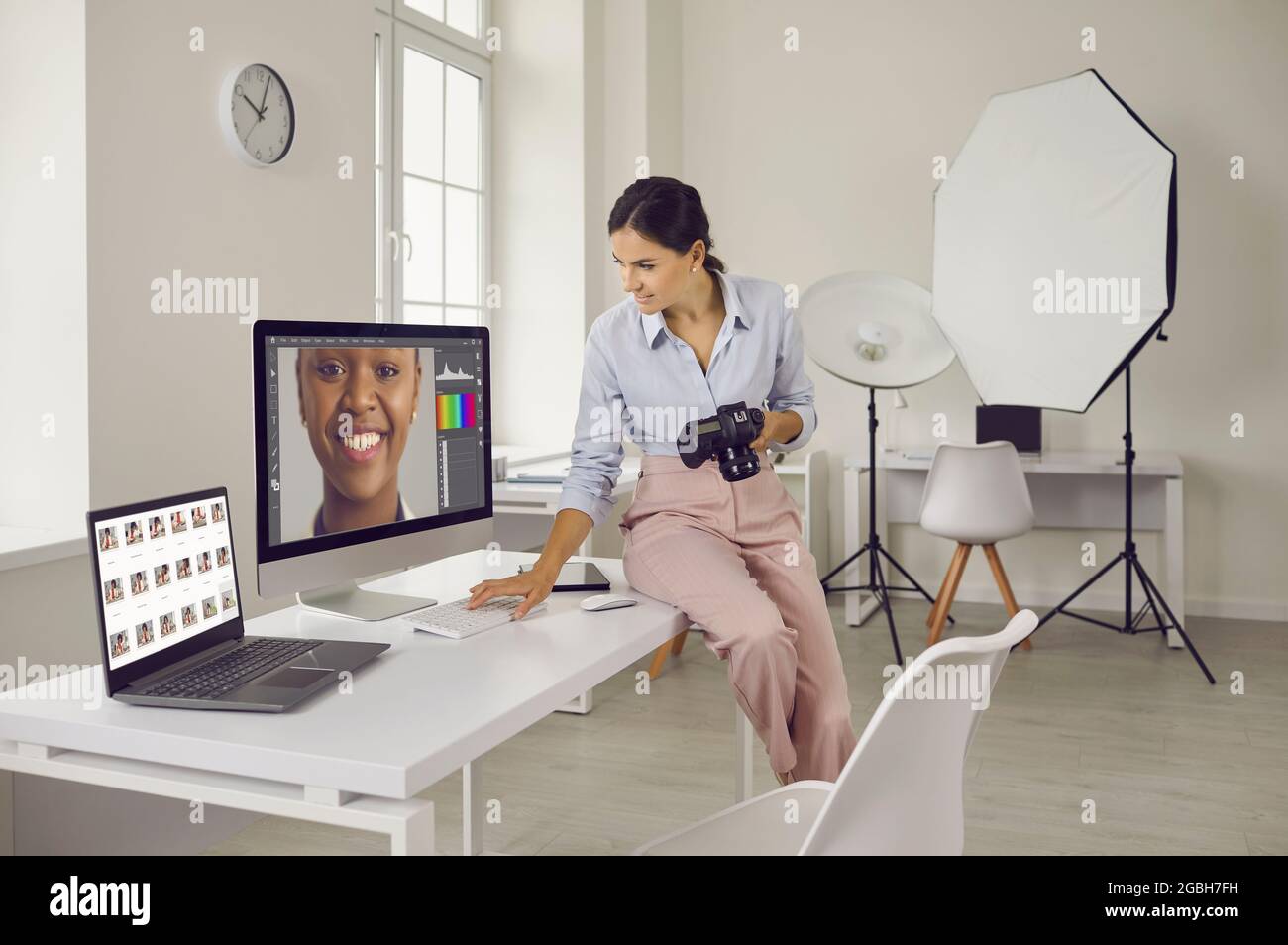 Female photographer working with female portraits at workplace with two ...