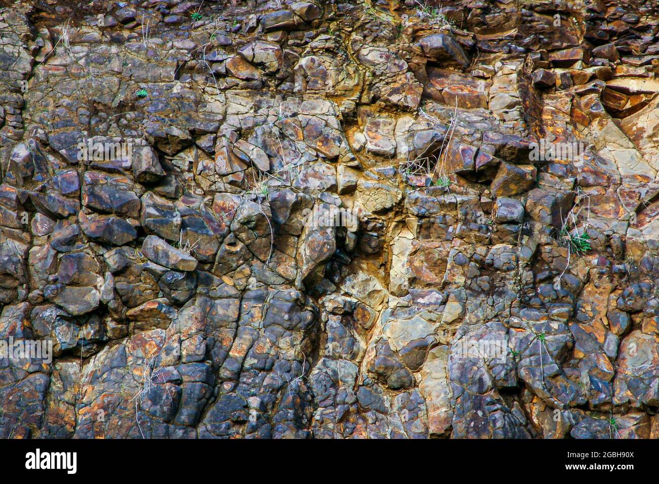 Black and brown rocky cliff face texture 01 Stock Photo - Alamy