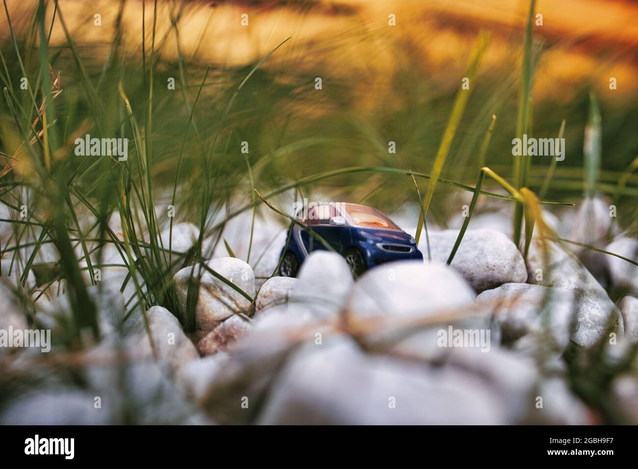 Small car which stands on a grass field Stock Photo - Alamy