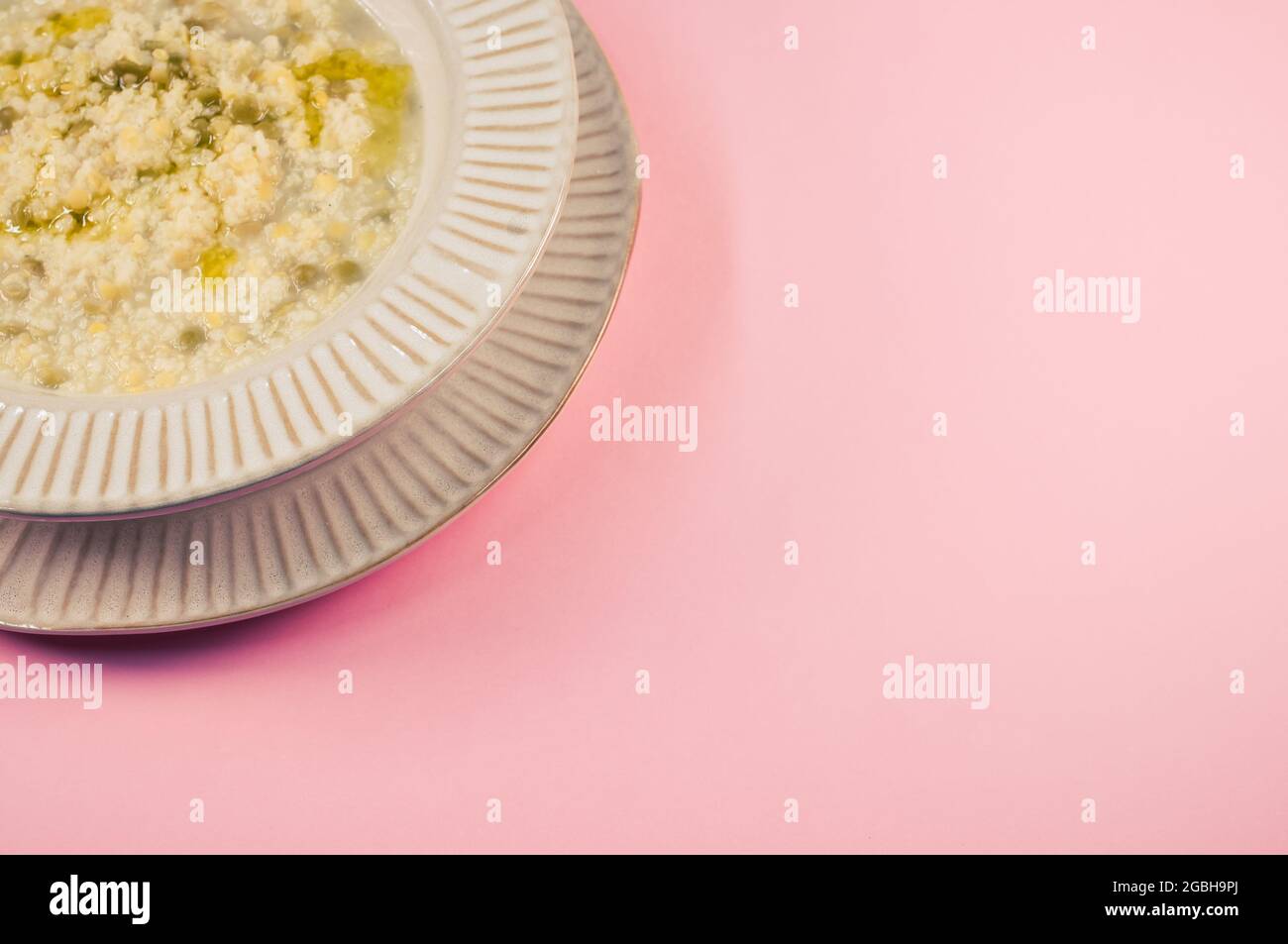 Plate of delicious porridge with corn and melted butter isolated on a ...