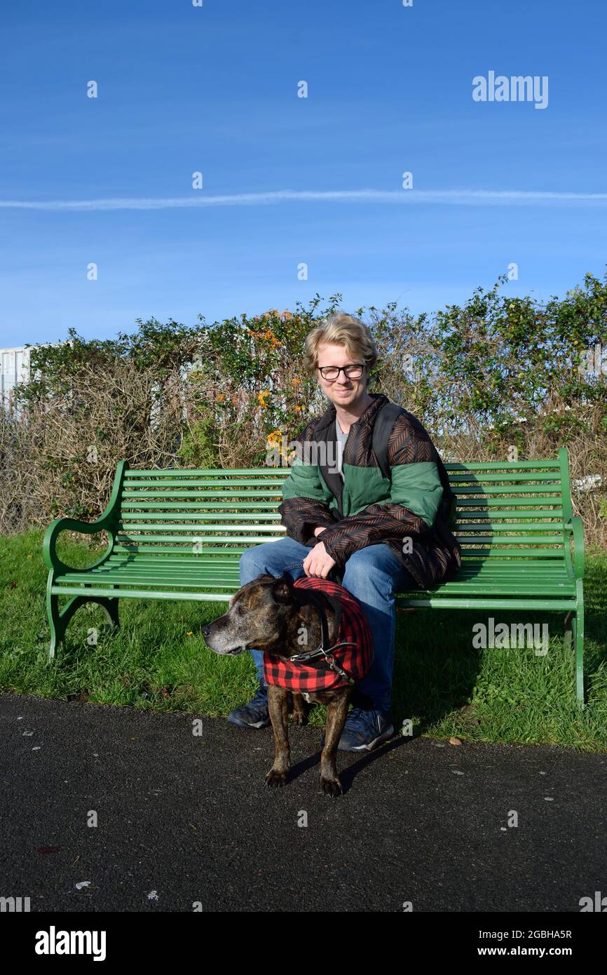 Cute Senior Dog with Owner Sitting on Bench in the Park Stock Photo - Alamy