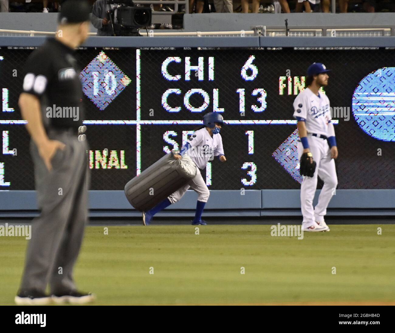 Los Angeles, United States. 04th Aug, 2021. A ballgirl removes a ...