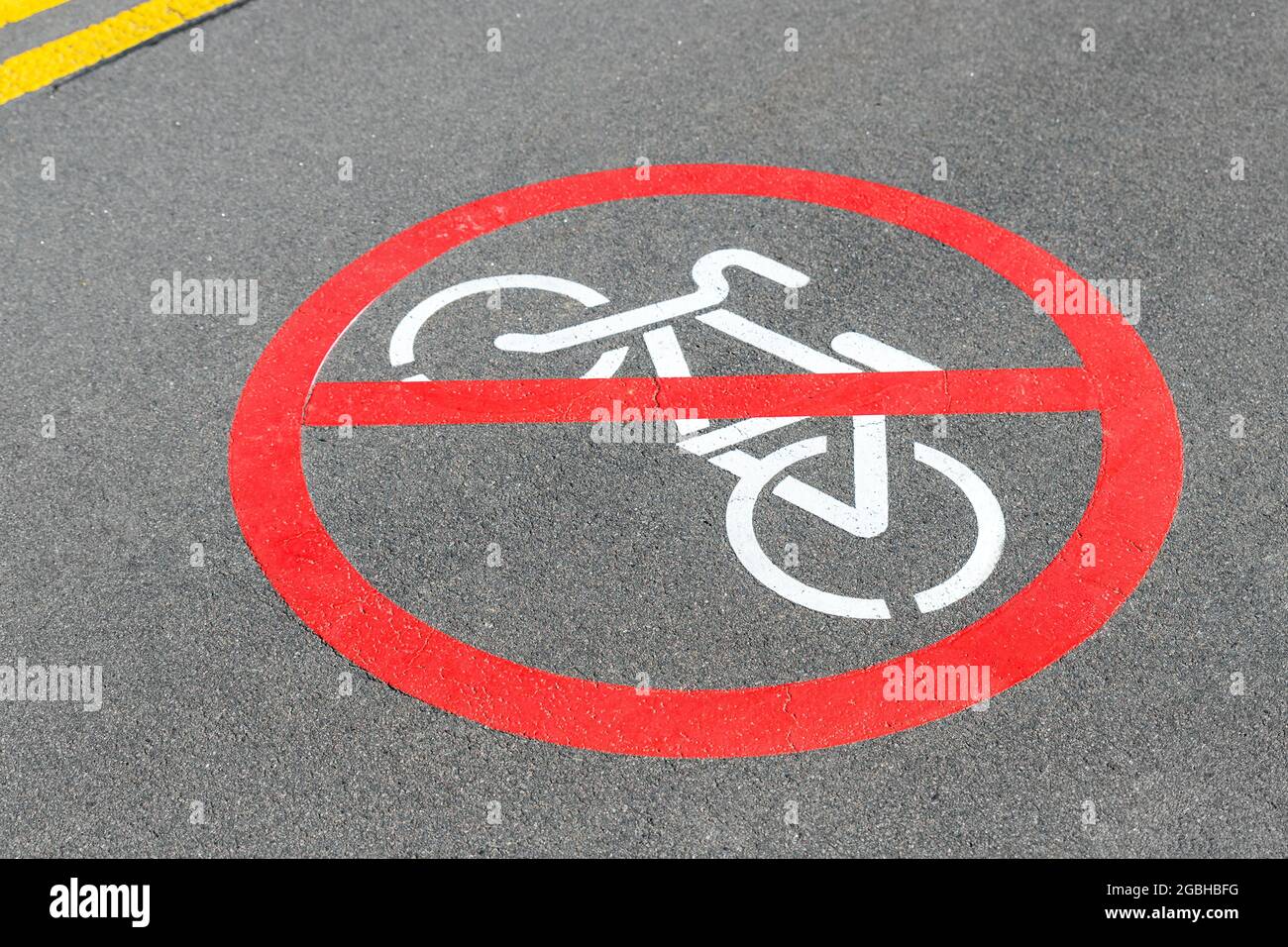 City street asphalt road with bicycle riding not allowed symbol sign ...