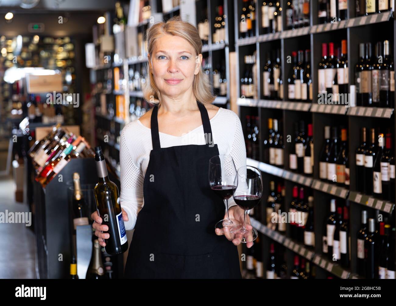 Woman owner of winery inviting to tasting wine Stock Photo - Alamy