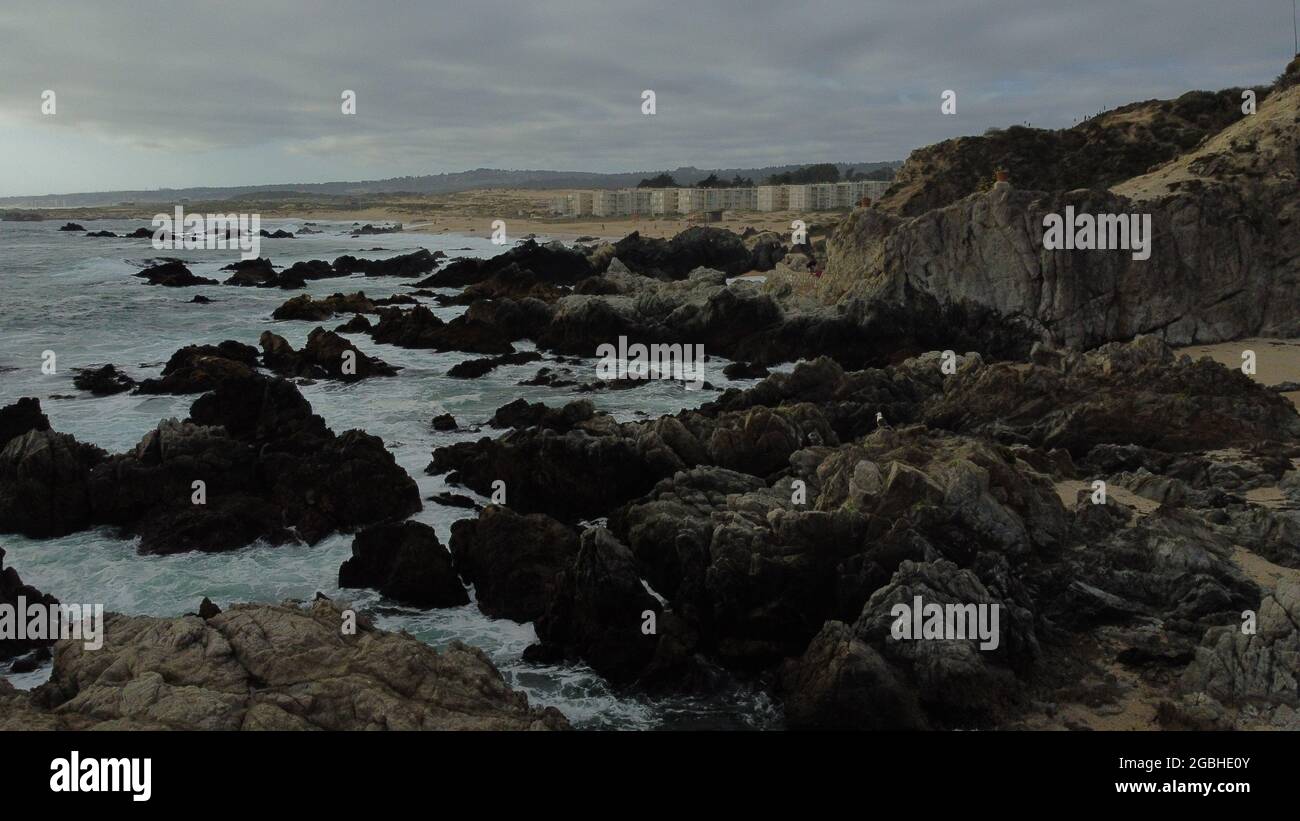 Aerial shot of a rocky shore and the calm sea on a cloudy day Stock ...