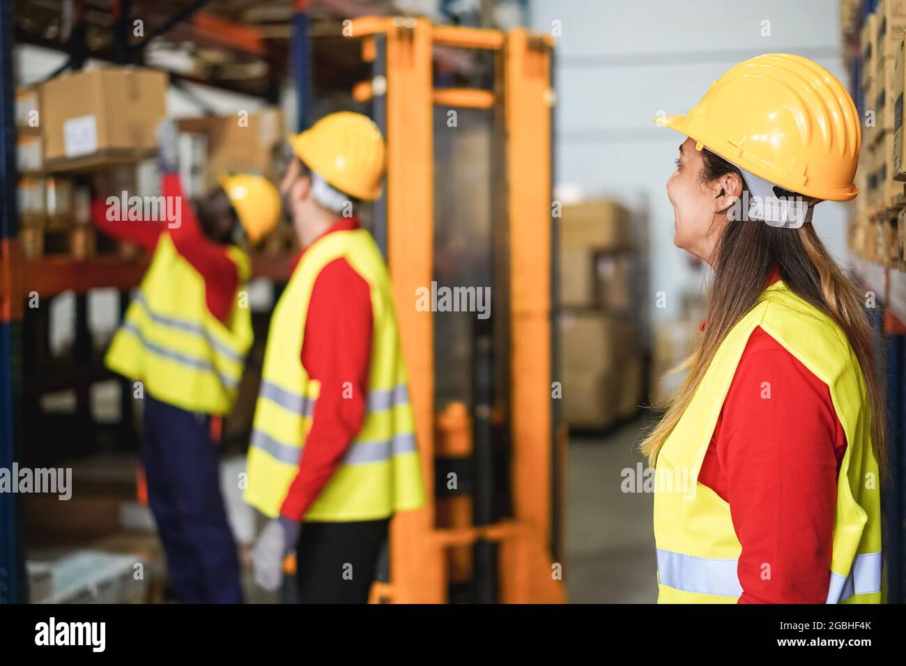 Industrial workers loading delivery boxes inside warehouse store ...