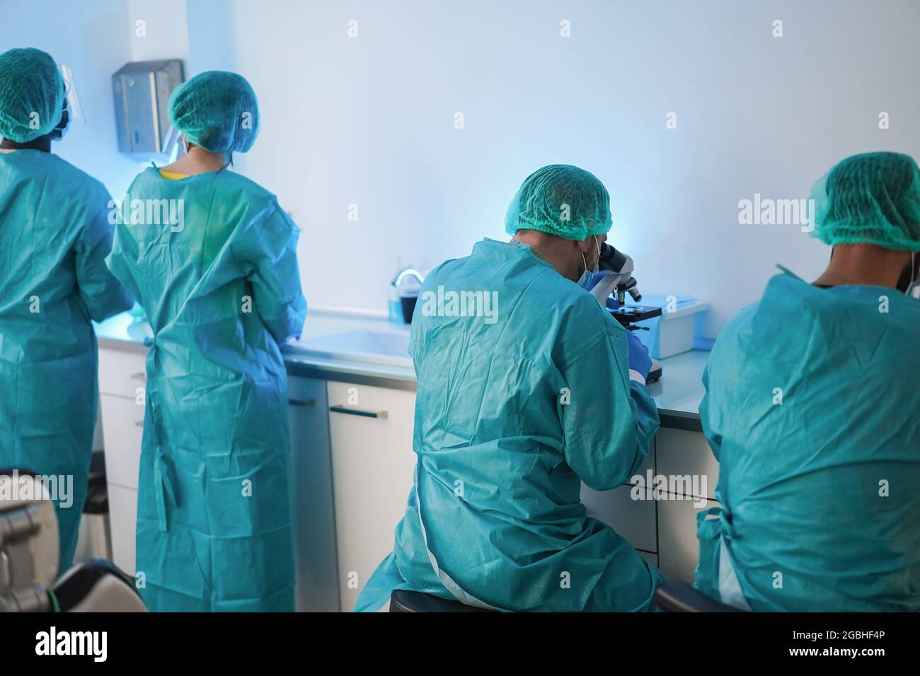 Medical workers using microscope and working inside hospital lab ...