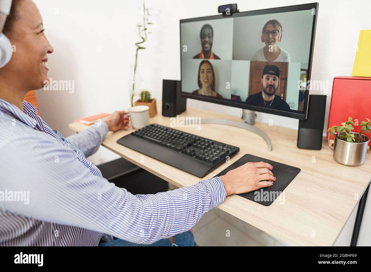 African woman having video call with her colleagues using computer app ...